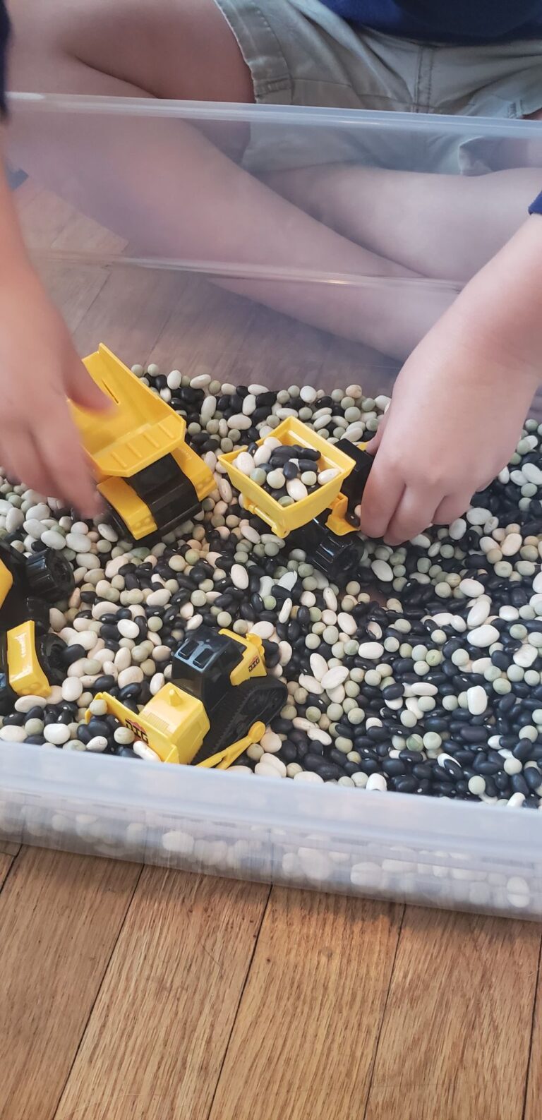 Construction Themed Sensory Bin with Mini Dump Trucks